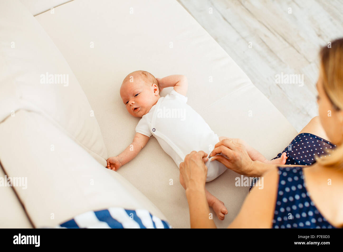 Mom dressing baby hi-res stock photography and images - Alamy