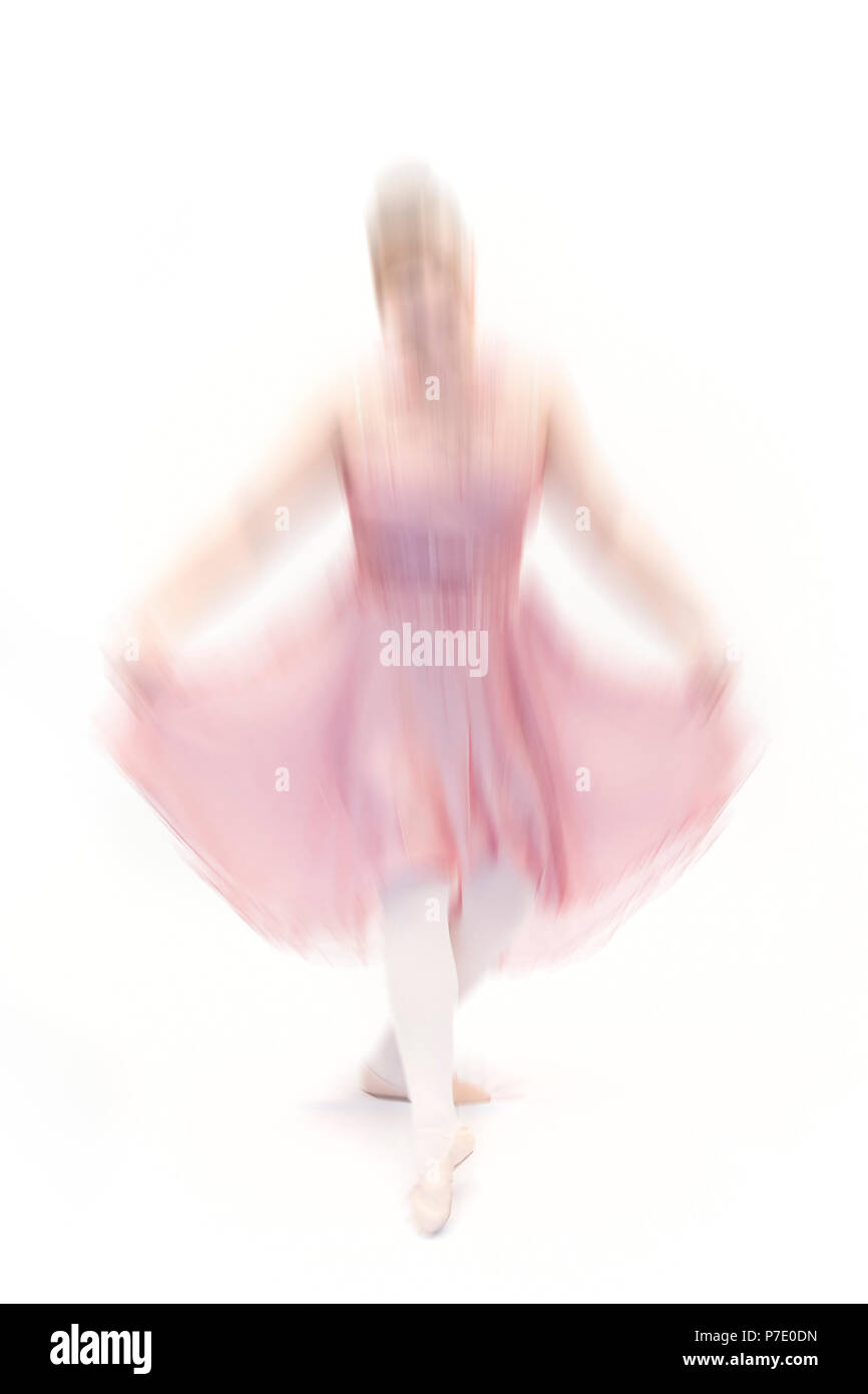 Blurred young ballet dancer posing on white background Stock Photo - Alamy