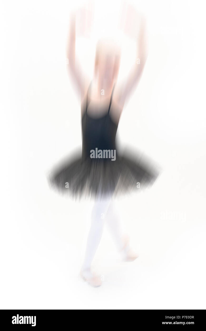 Blurred young ballet dancer posing on white background Stock Photo - Alamy