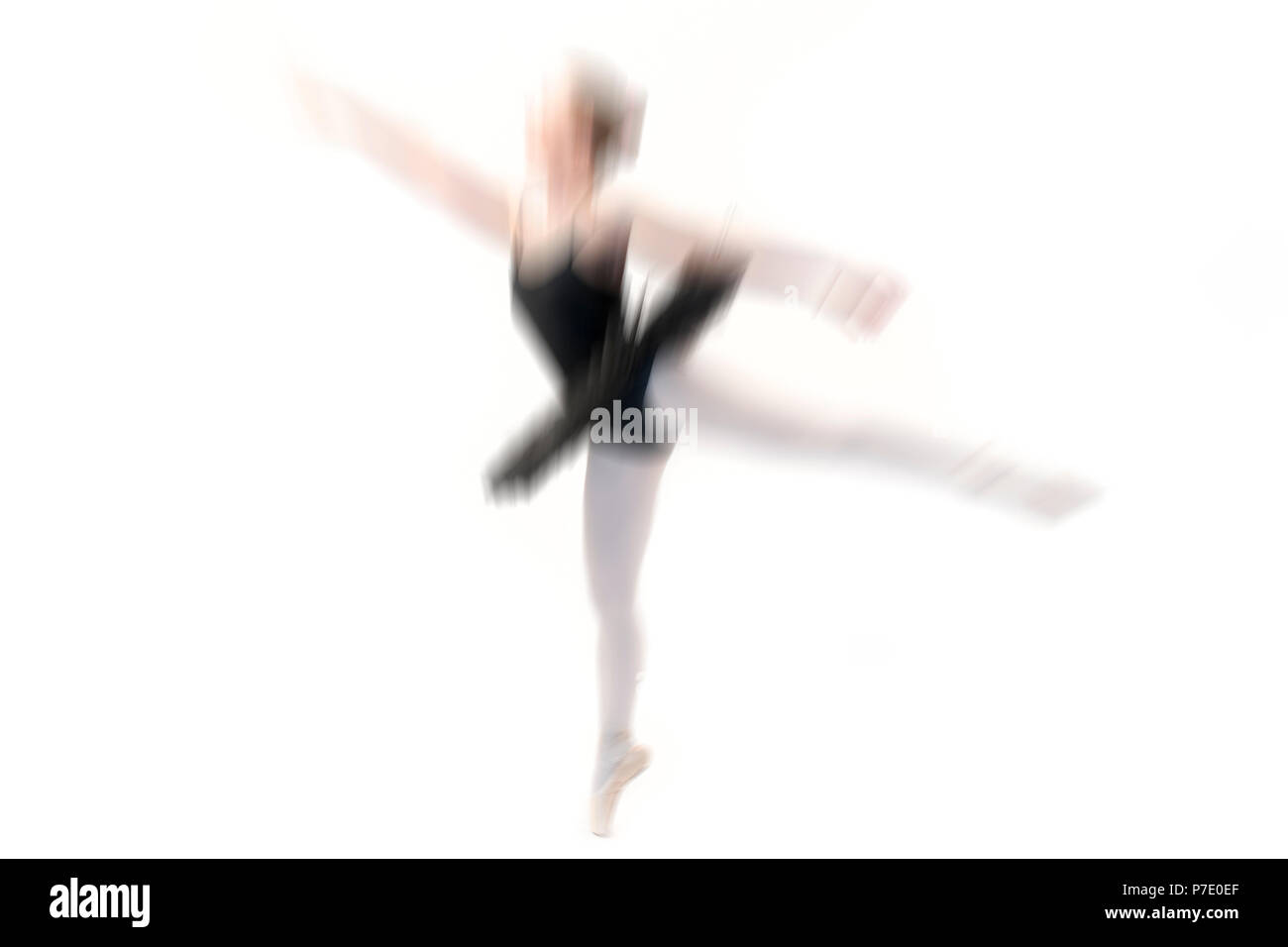 Blurred young ballet dancer posing on white background Stock Photo - Alamy