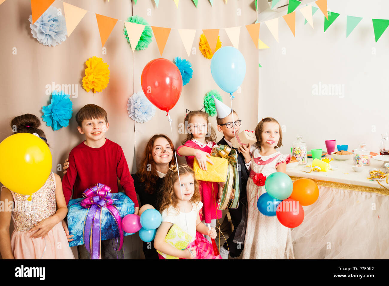 Children bring the presents to their friend Stock Photo - Alamy