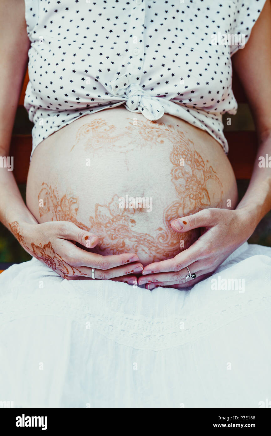 Close view of woman's pregnant belly Stock Photo - Alamy