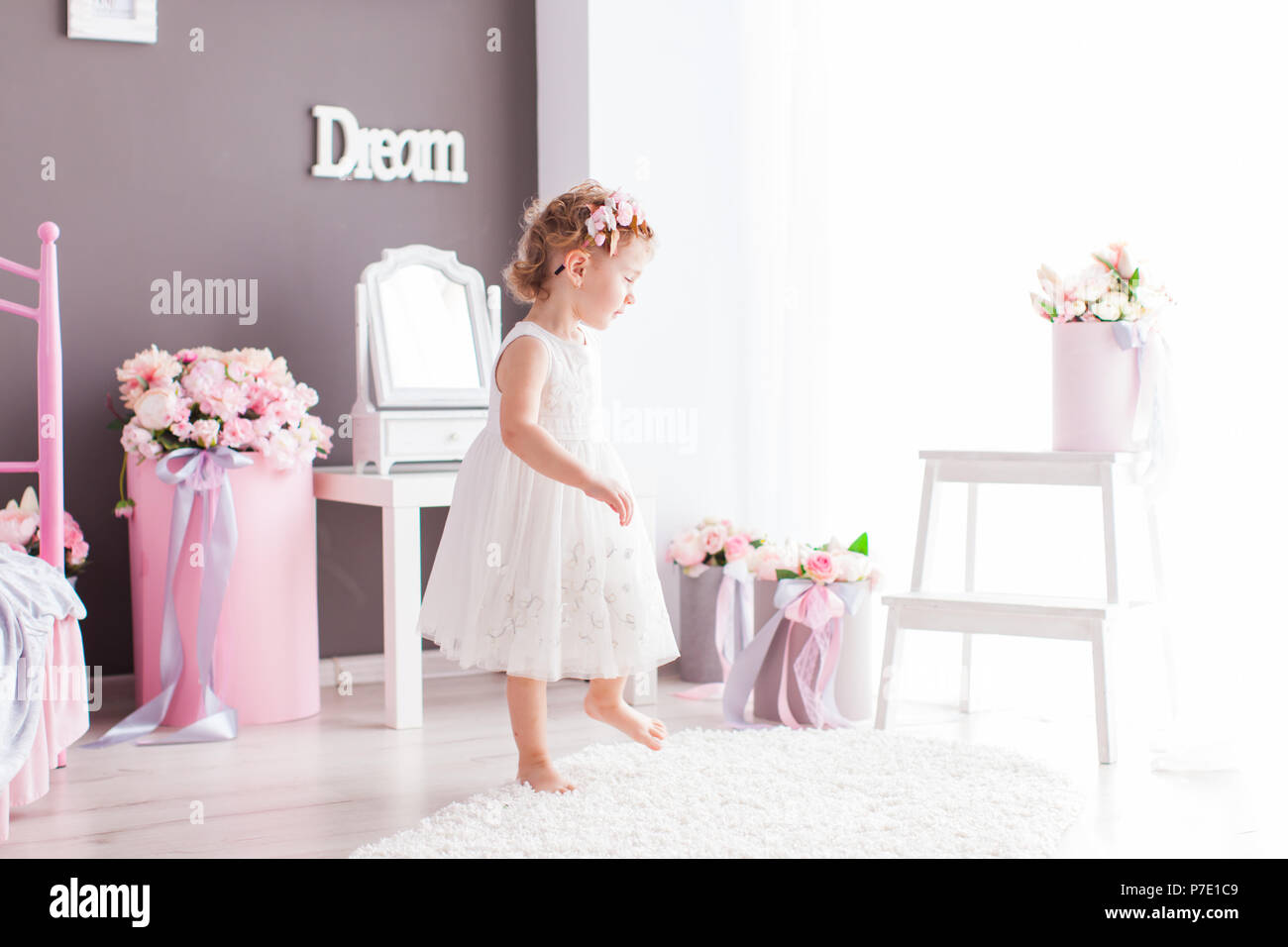 Pretty girl standing in her light girly room Stock Photo - Alamy