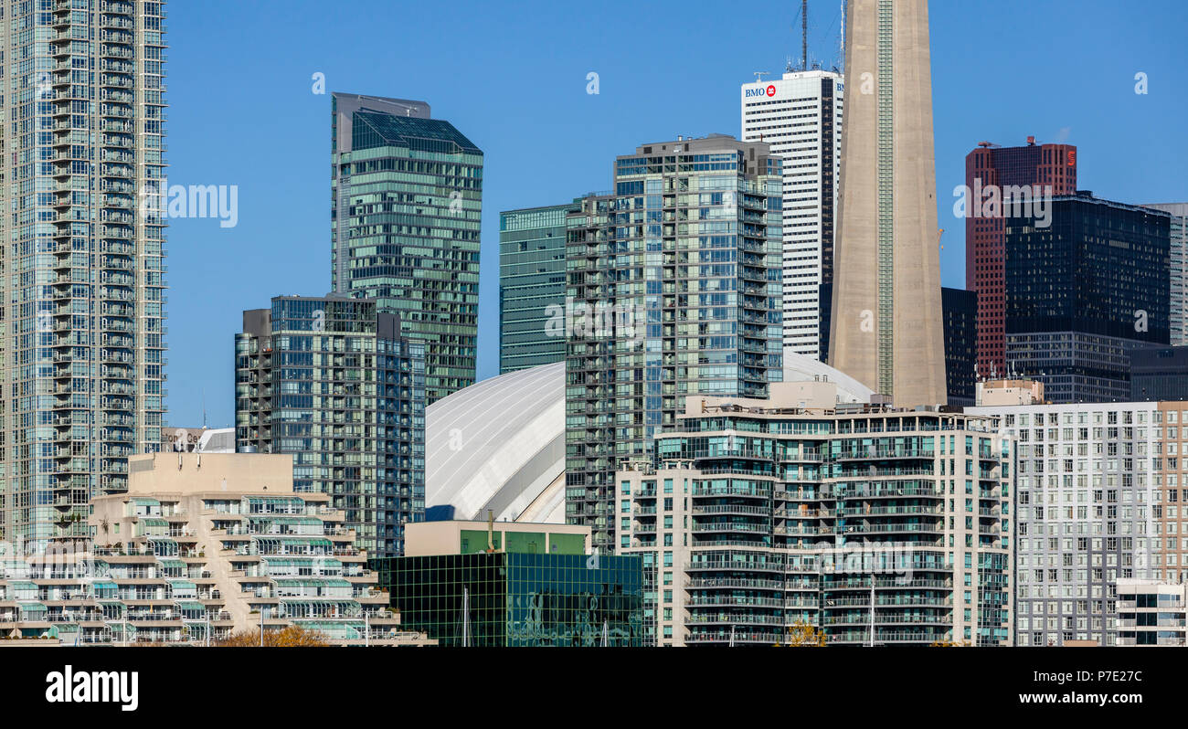 Closeup of condos from the waterfront, with the base of the Cn Tower ...