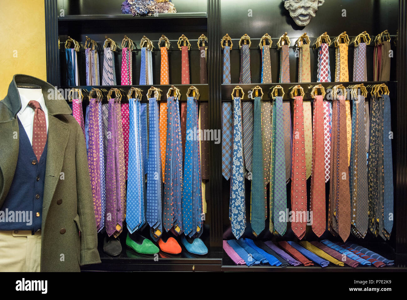 Rows of ties and tailors dummy in traditional tailors shop Stock Photo ...