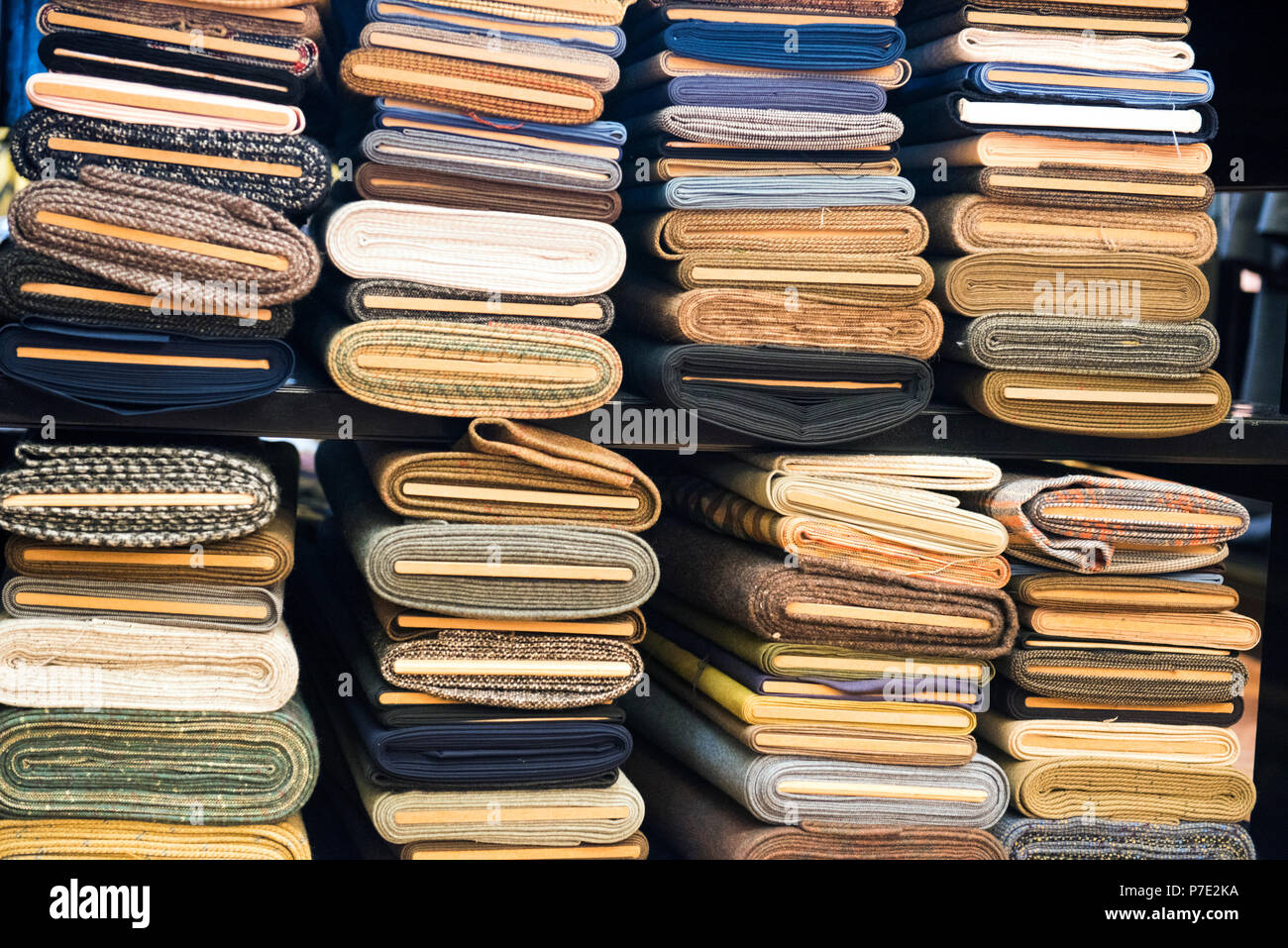 Stacks of rolled cloth in traditional tailors shop Stock Photo - Alamy