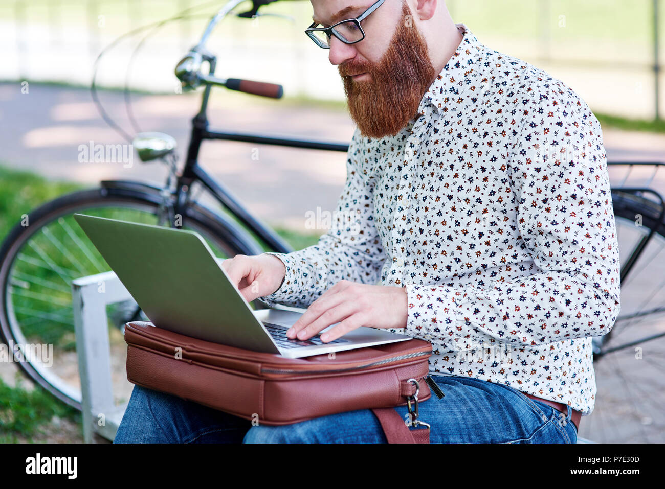 Bearded man using laptop Stock Photo - Alamy
