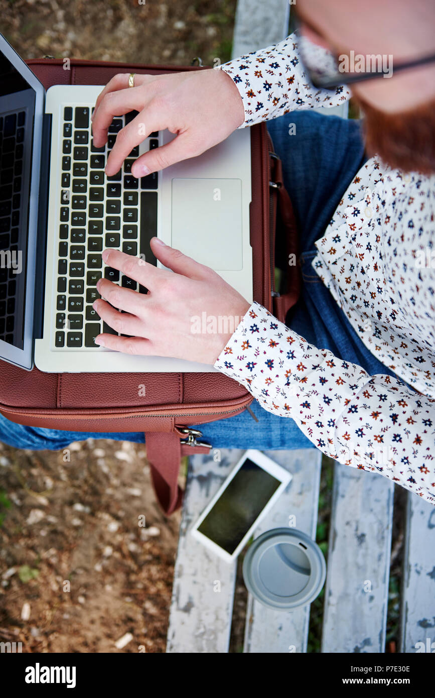 Overhead view of man using laptop computer Stock Photo - Alamy