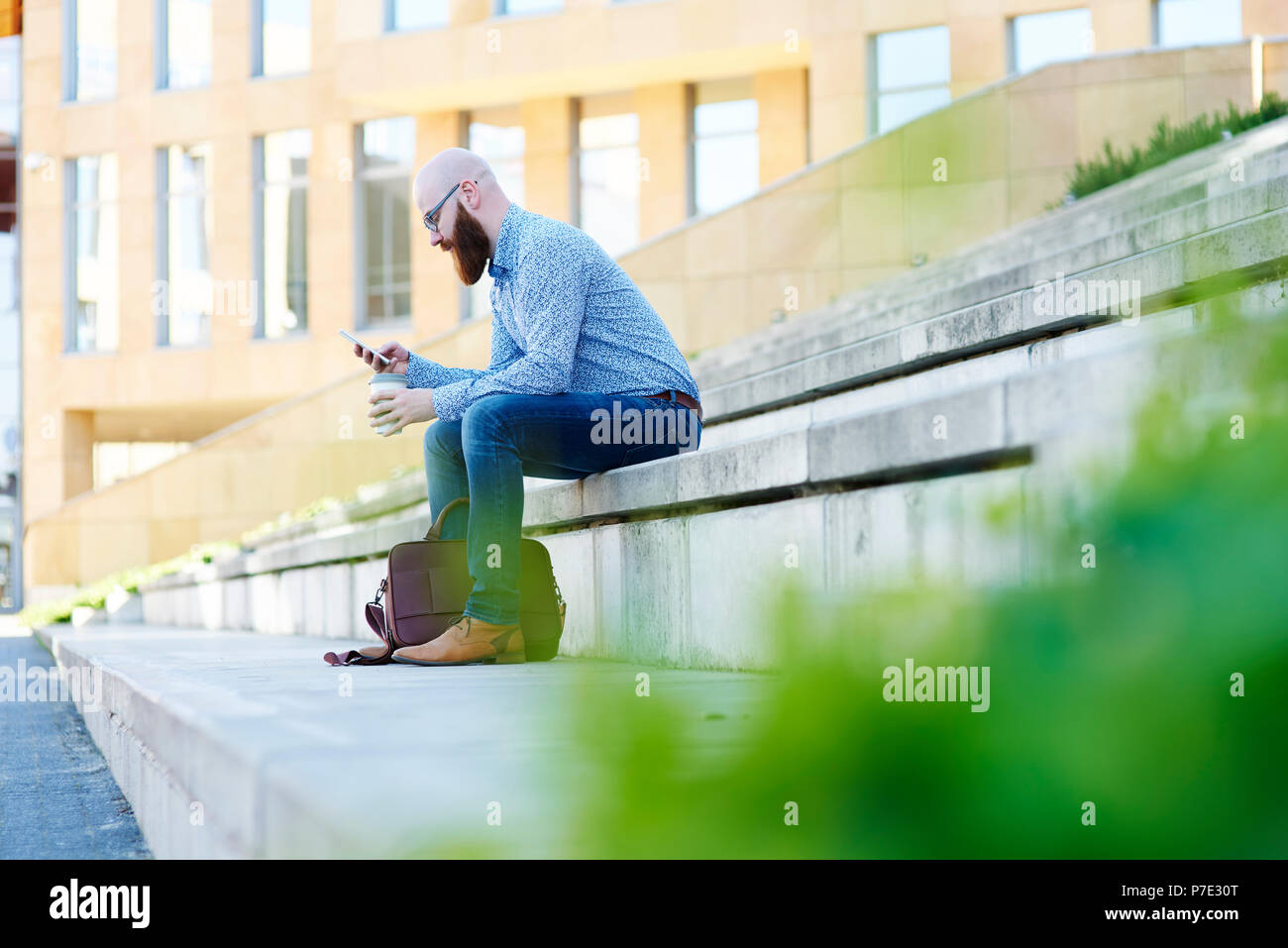 Man sitting on step hi-res stock photography and images - Alamy