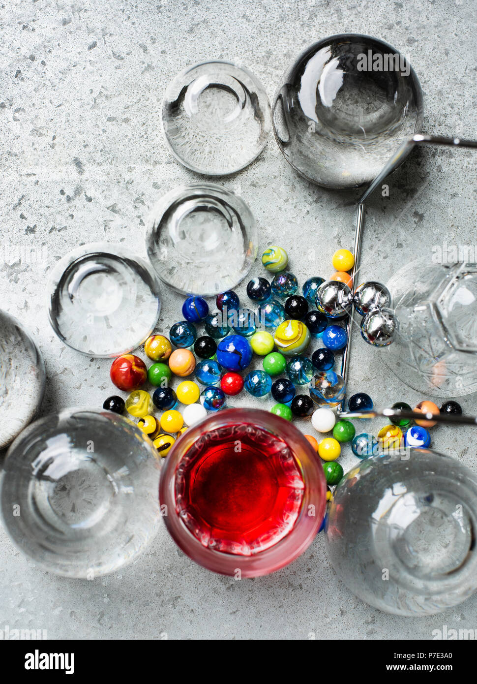 Drinking glasses and marbles, overhead view Stock Photo - Alamy
