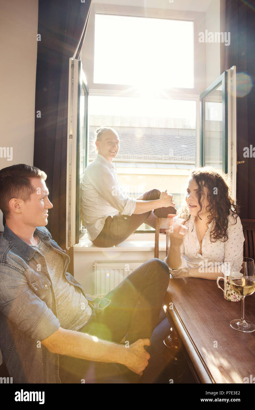 Group of friends chatting over drinks at home Stock Photo - Alamy