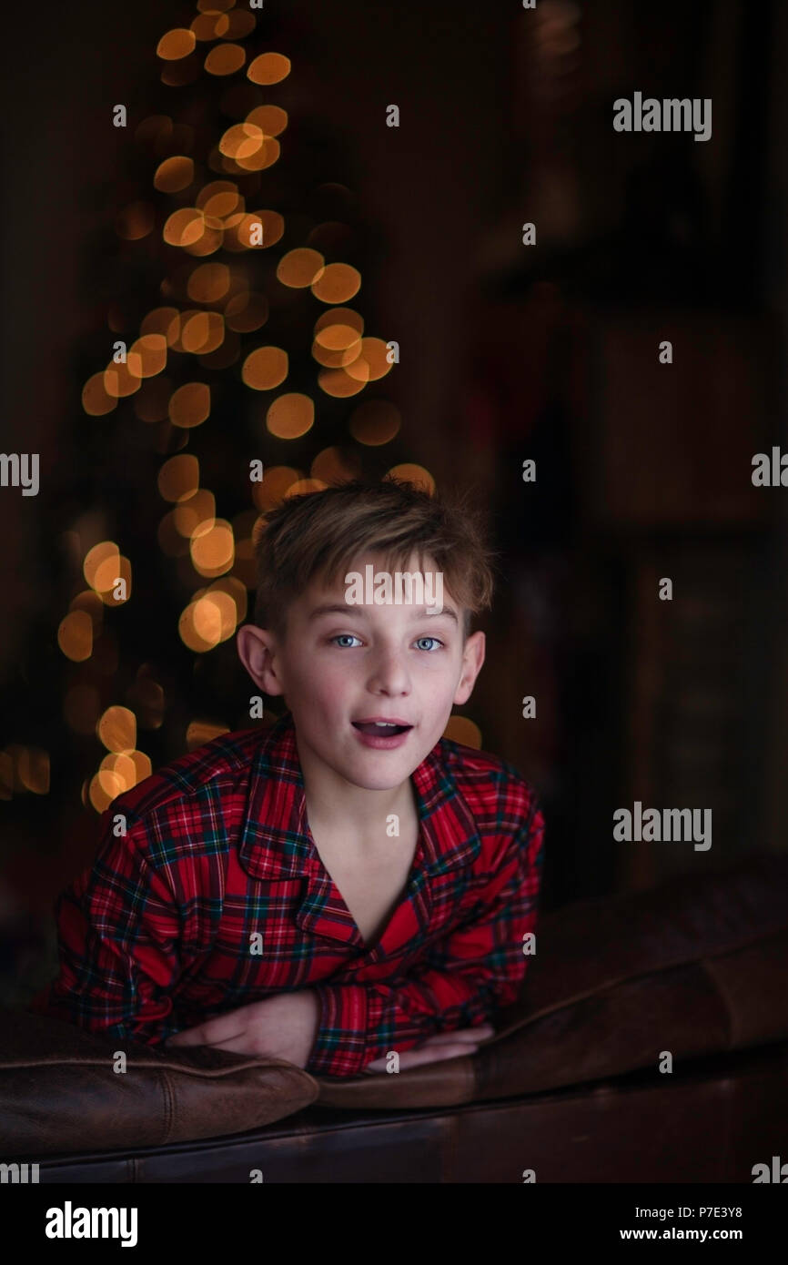 Boy leaning against tree hi-res stock photography and images - Alamy