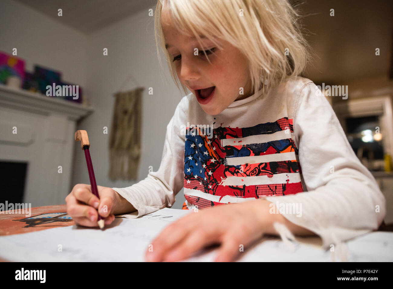 Boy doing homework with color pencil hi-res stock photography and ...