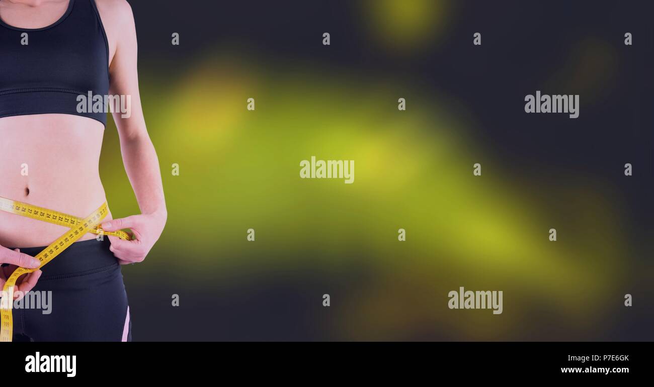 Woman measuring weight with measuring tape on waist in Summer Stock ...