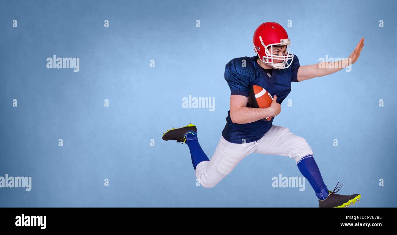 American football player with blank blue background Stock Photo - Alamy