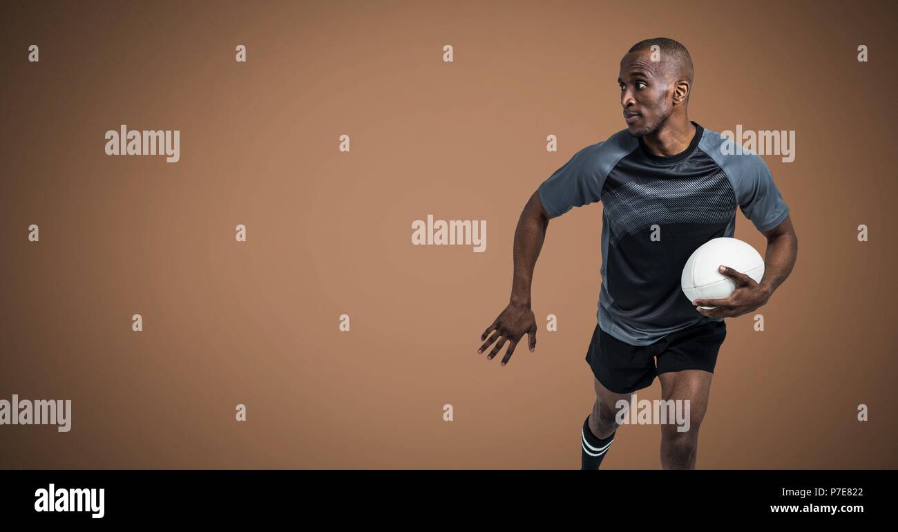 Rugby player running with ball with blank brown background Stock Photo ...