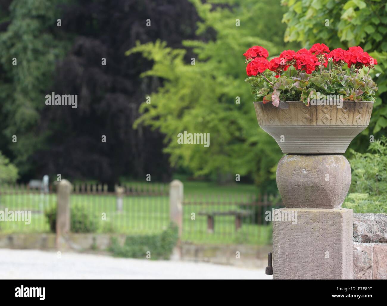 A flower arrangement on a old stone column in front of the castle park ...