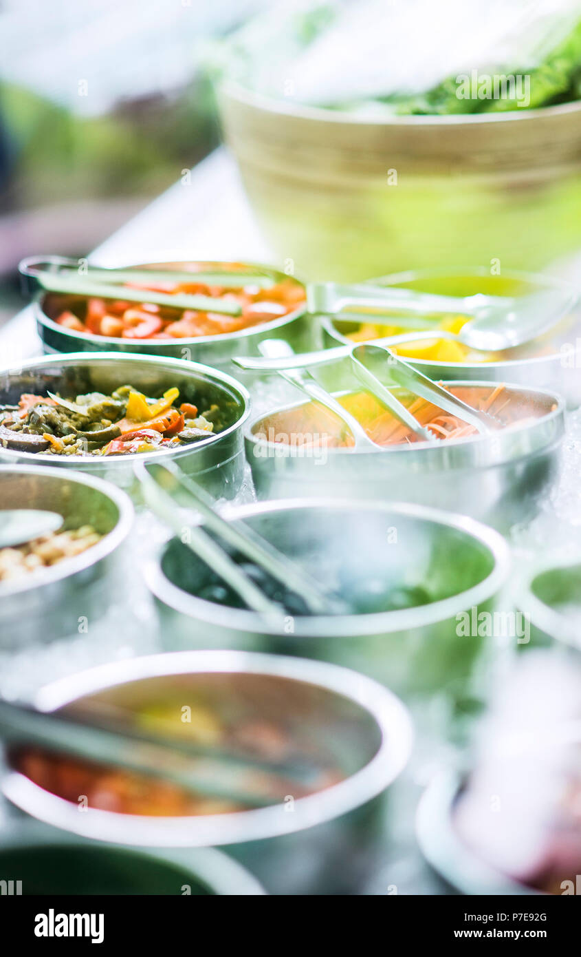 bowls of mixed fresh organic vegetables in modern salad bar display ...