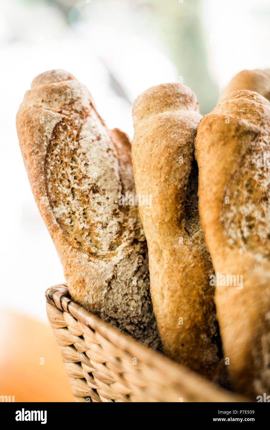 mixed french organic french baguette bread in rustic bakery display ...