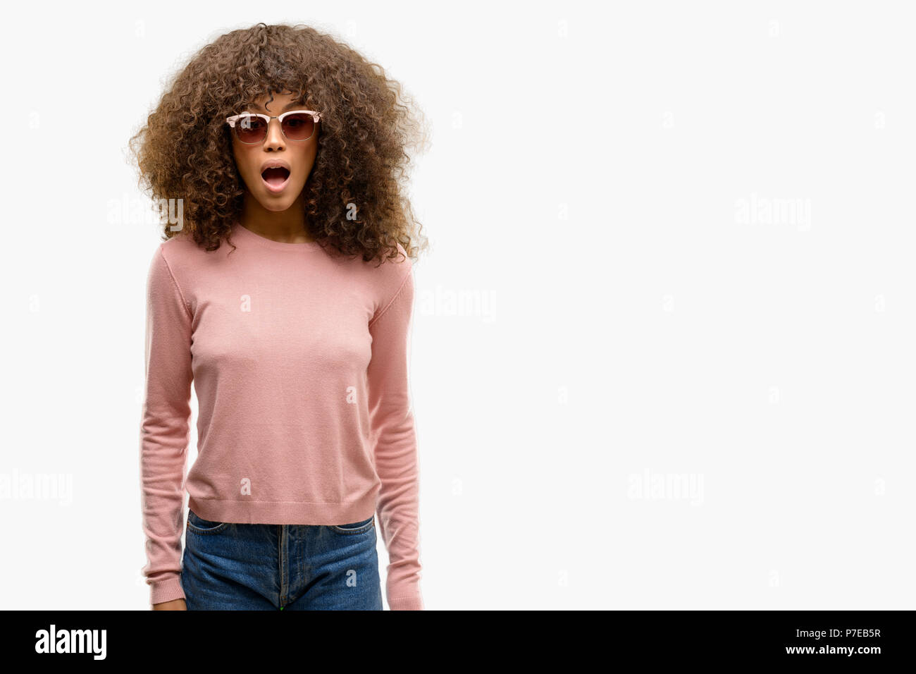 Woman wearing pink sweater jeans Cut Out Stock Images & Pictures - Alamy