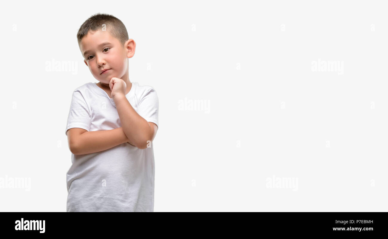 Dark haired little child serious face thinking about question, very ...