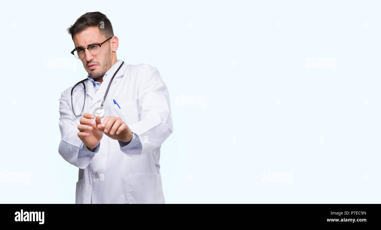 Handsome young doctor man disgusted expression, displeased and fearful ...