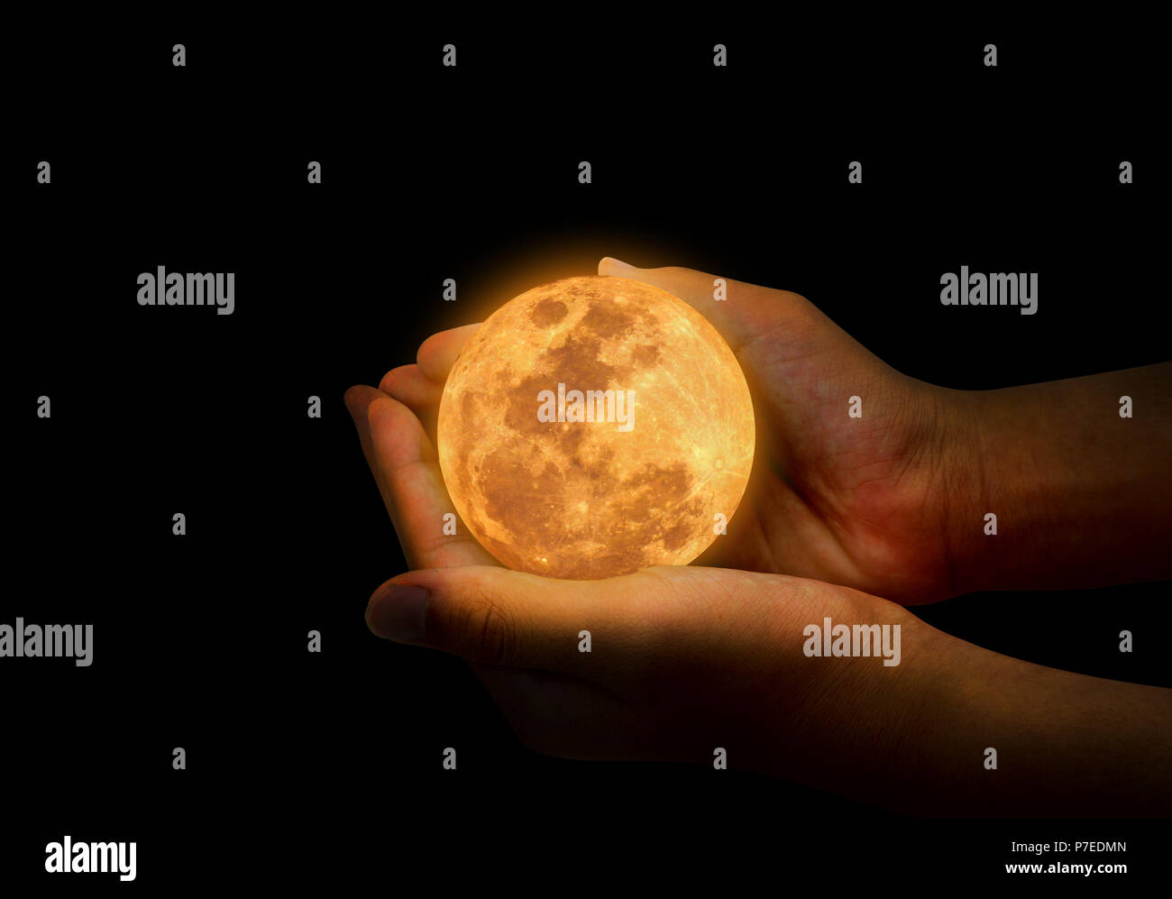 Female hand hold yellow full moon on her hand. A full moon is the lunar ...