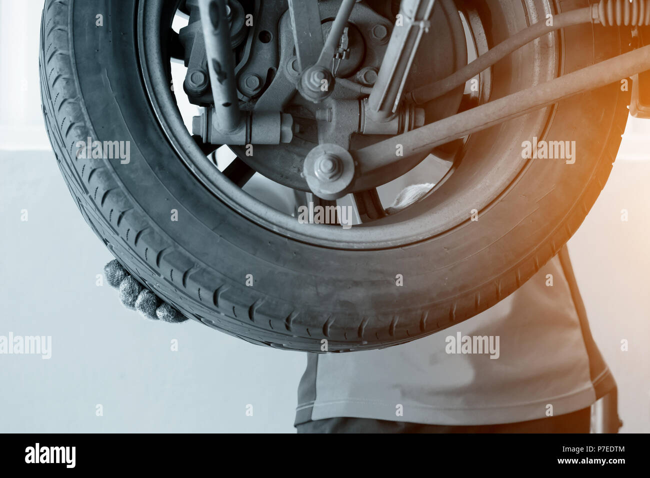 focus in hand changing tyre of car, - sunlight filter effect Stock ...