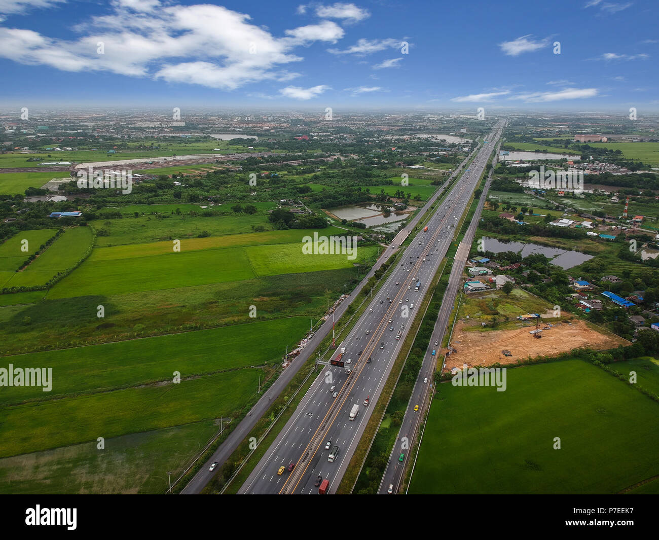 Aerial view of rural tree covered countryside with highway of road ...