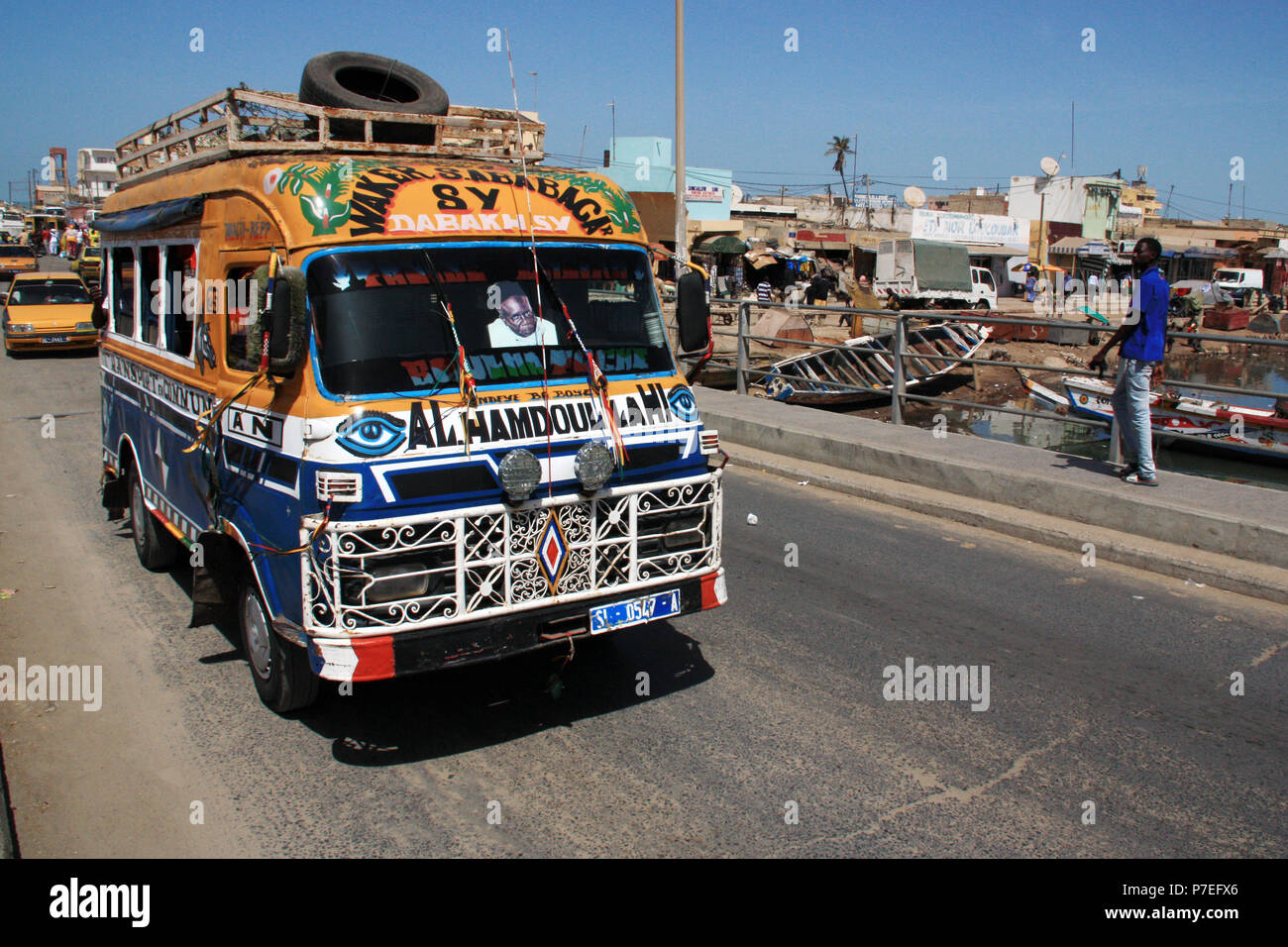 Colorful painted public bus crossing a bridge and leaving the city ...