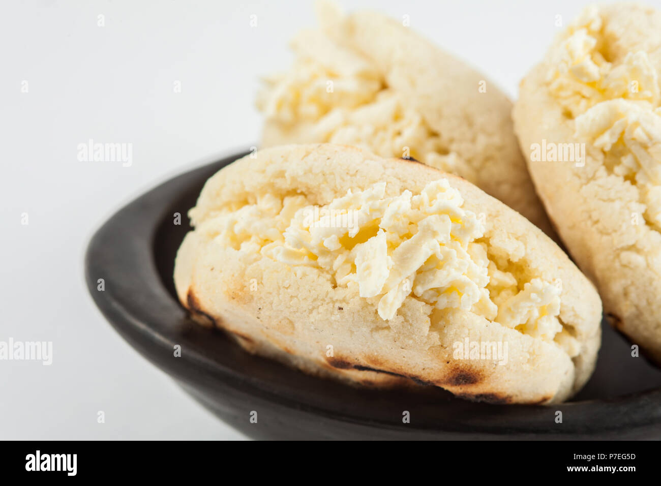 Colombian traditional white corn arepa stuffed with grated cheese in a ...