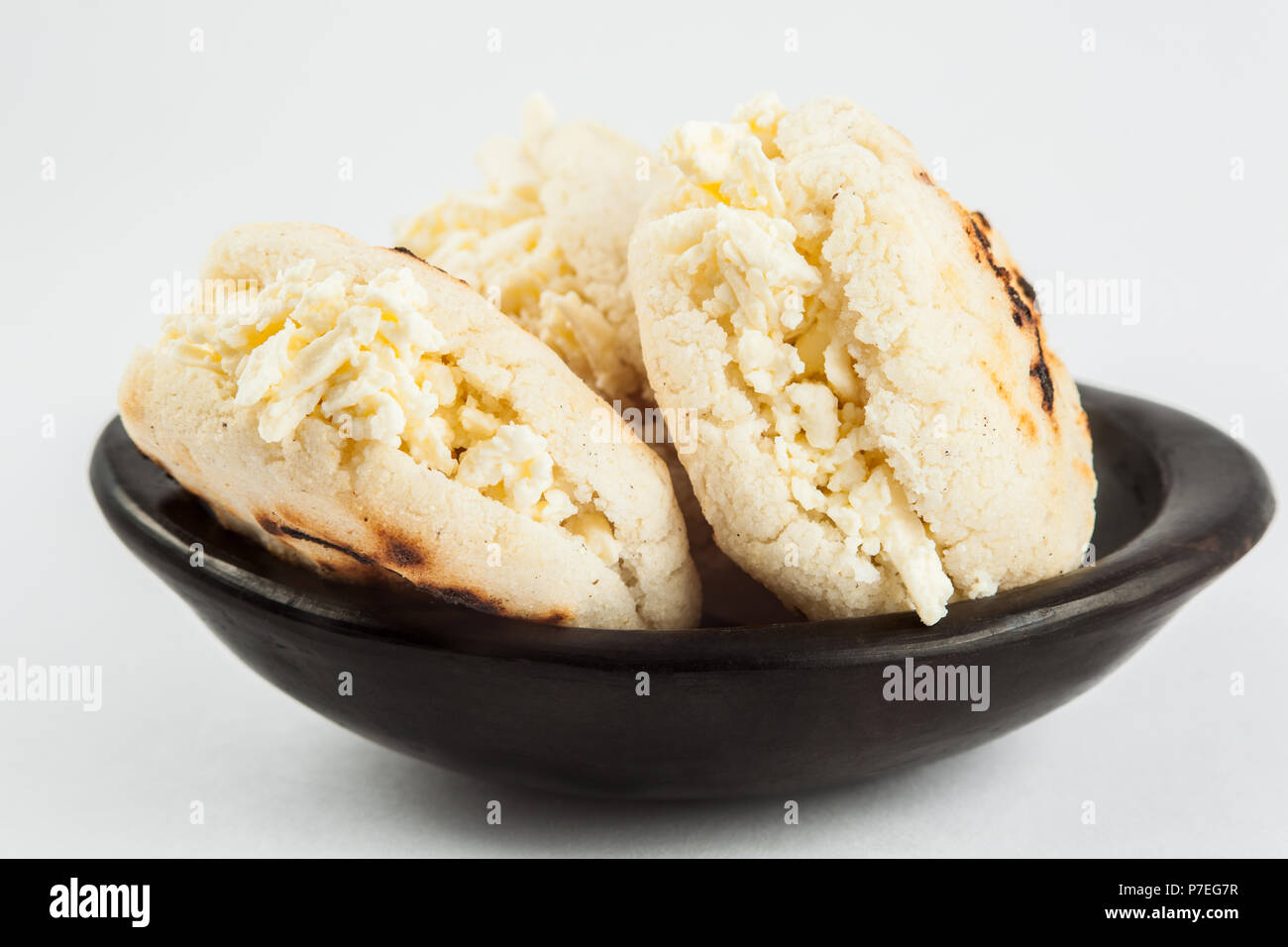 Colombian traditional white corn arepa stuffed with grated cheese in a ...