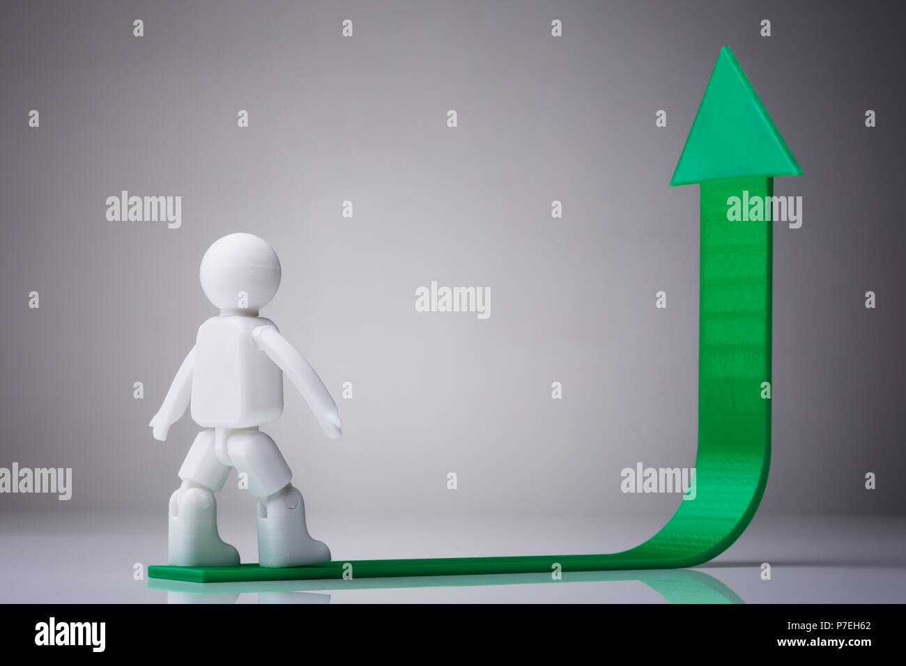 Human Figure Walking On Green Arrow Pointing Upward Stock Photo - Alamy