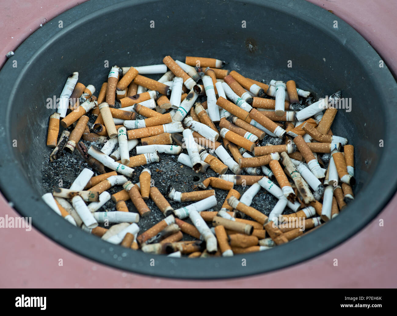 Madison WI, USA, Jun 28, 2018. Black ashtray full of cigarette butts ...