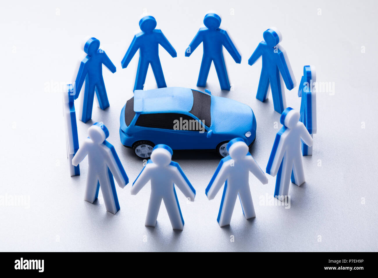 Elevated View Of Blue Car Surrounded By Human Figures On White ...