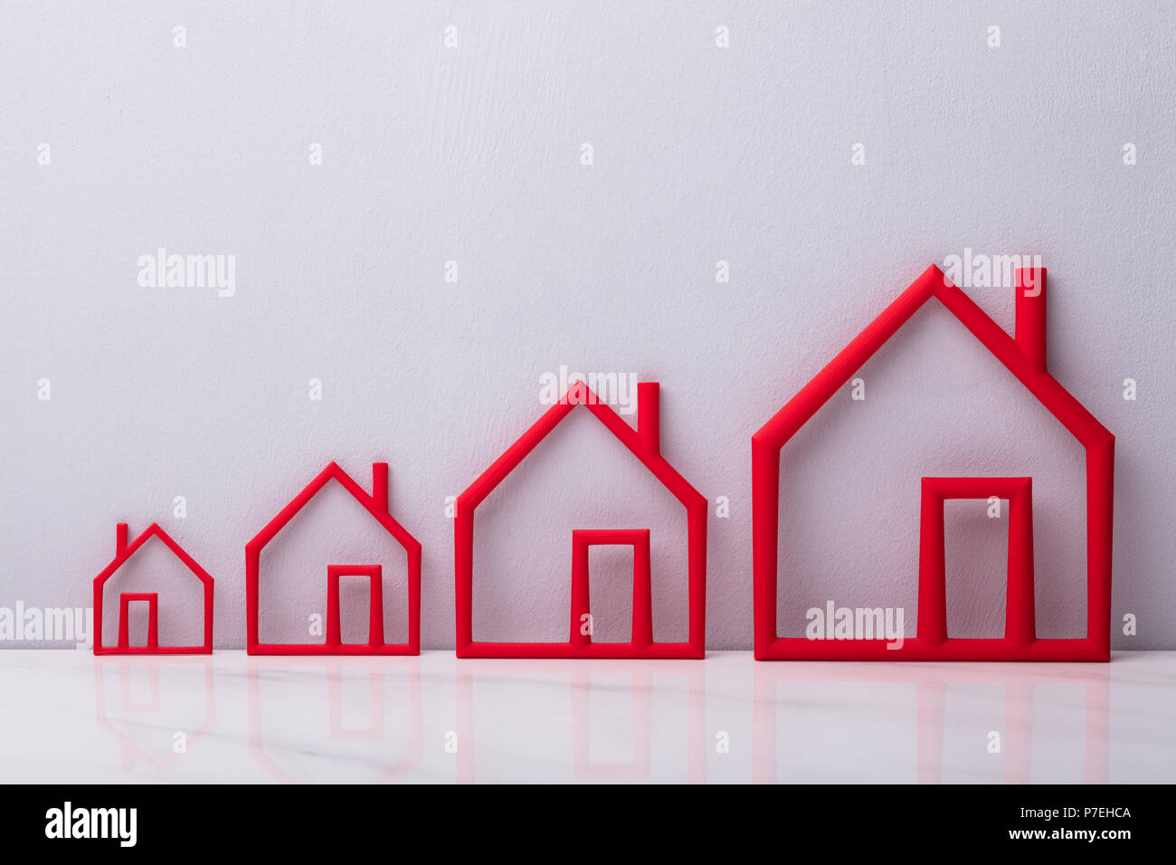 Increasing Outline Of Red Houses Against White Background Stock Photo ...