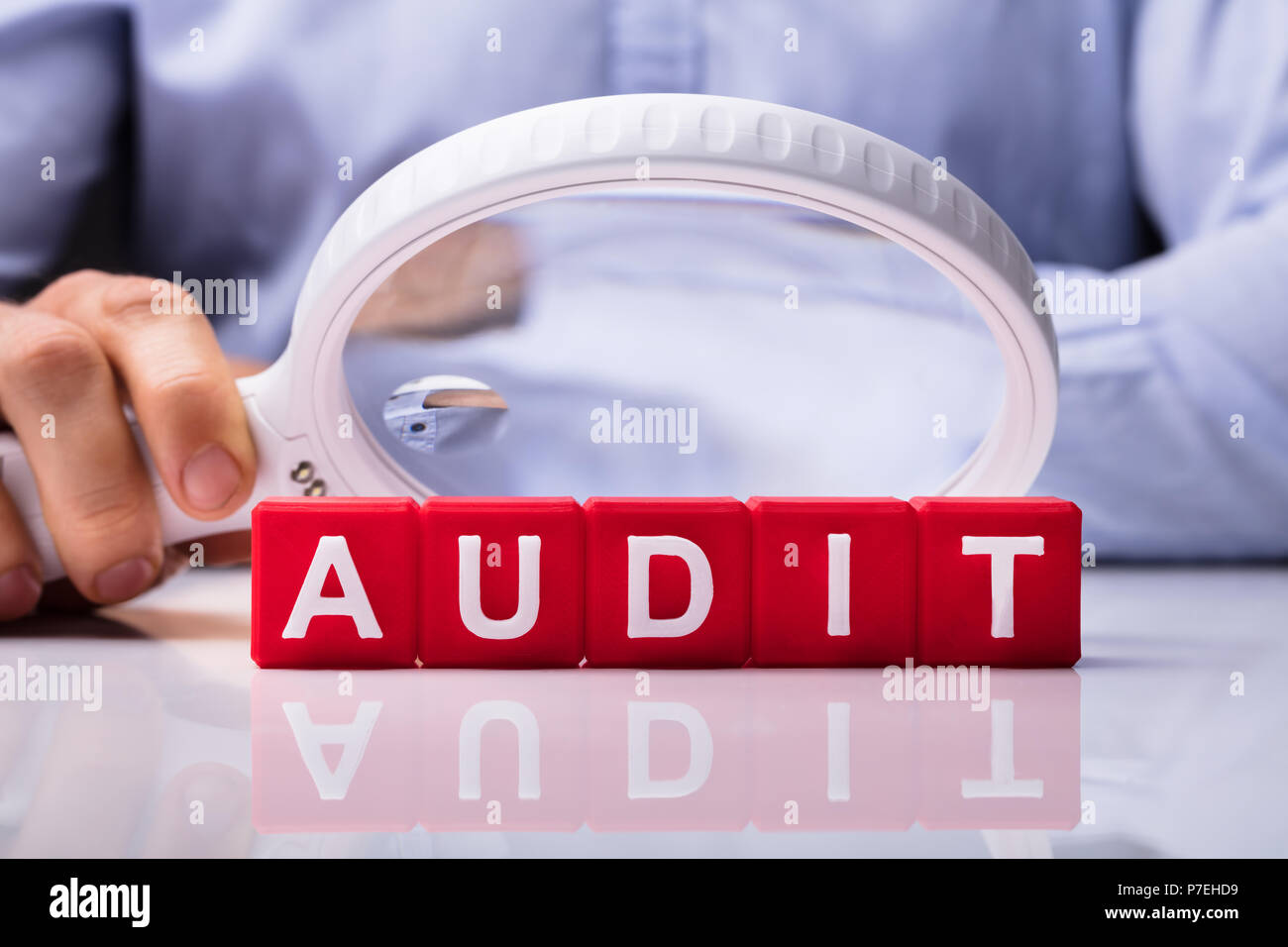 Close-up Of A Hand Examining Red Audit Blocks Through Magnifying Glass ...