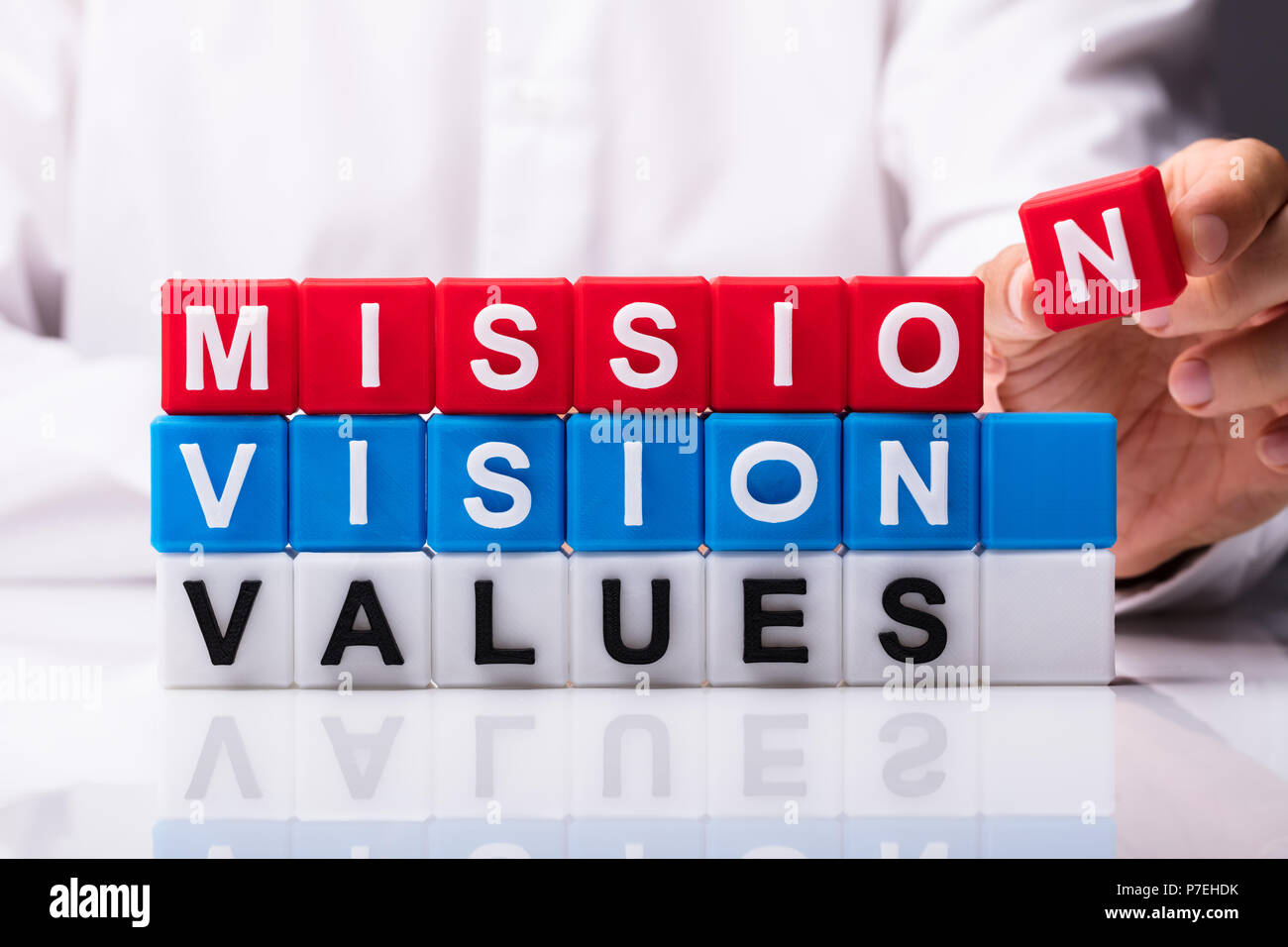 Person Building Colorful Cubic Blocks With Mission, Vision And Values ...