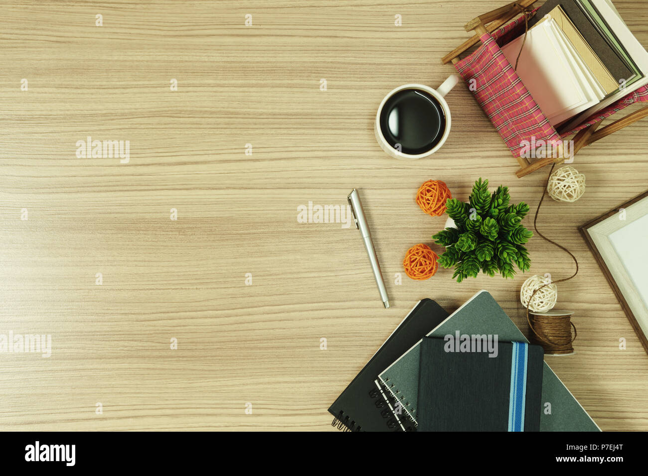 Stack of books with greeting cards and coffee on wood background ...