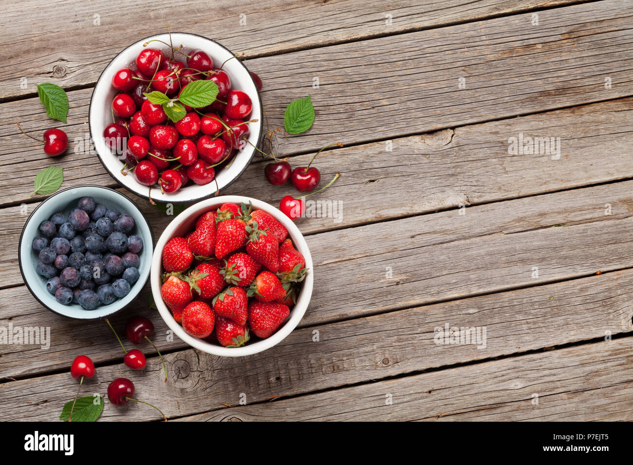 Fresh summer berries. Cherry, blueberry and strawberry. Top view with ...