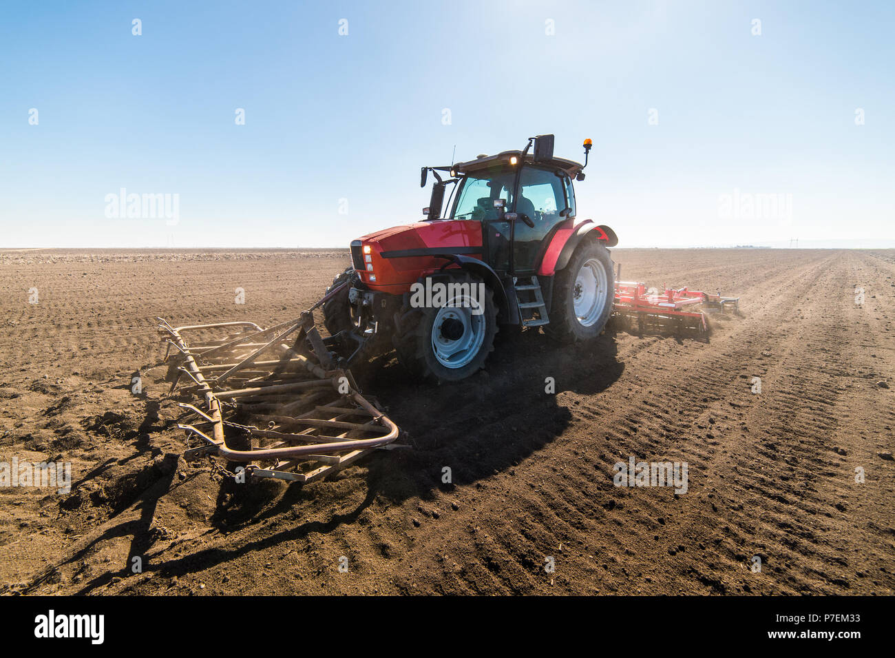 Tractor preparing land for sowing Stock Photo - Alamy