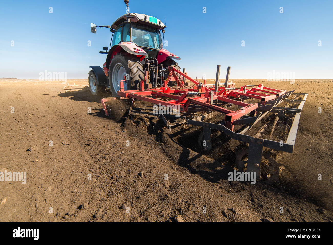 Tractor preparing land for sowing Stock Photo - Alamy