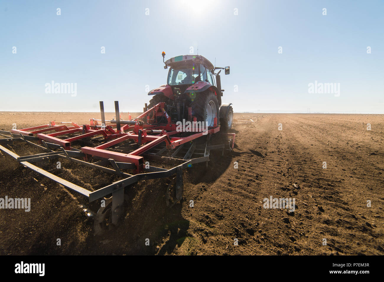 Tractor preparing land for sowing Stock Photo - Alamy