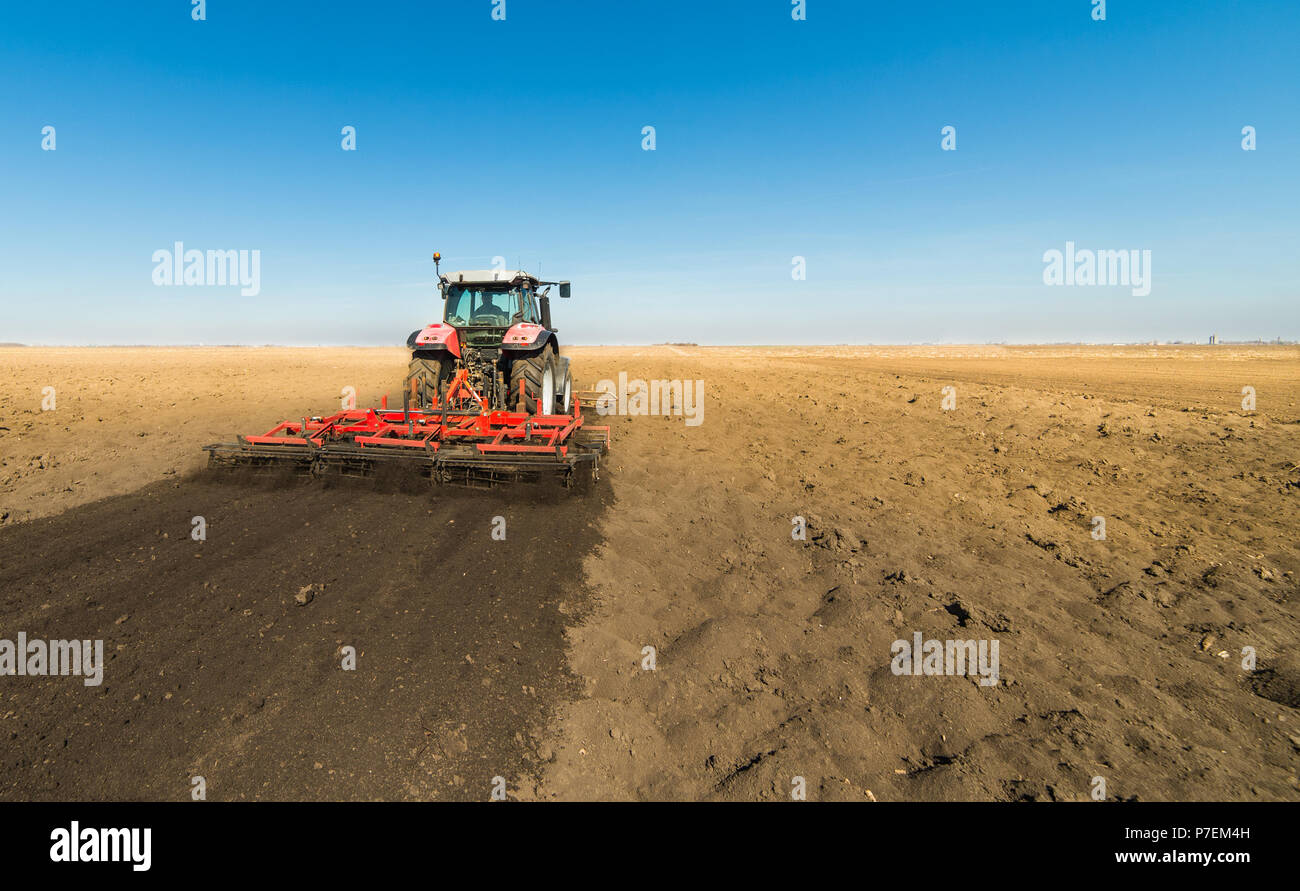 Tractor preparing land for sowing Stock Photo - Alamy