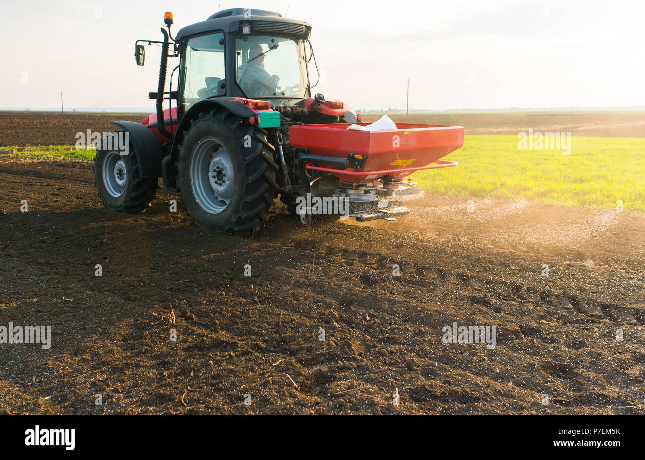 Tractor spreading artificial fertilizers in field Stock Photo - Alamy