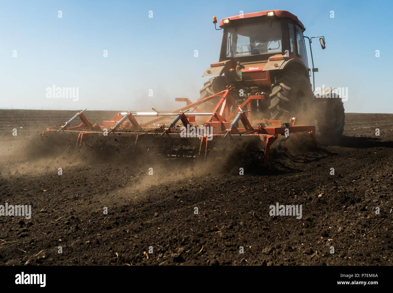 Tractor preparing land for sowing Stock Photo - Alamy