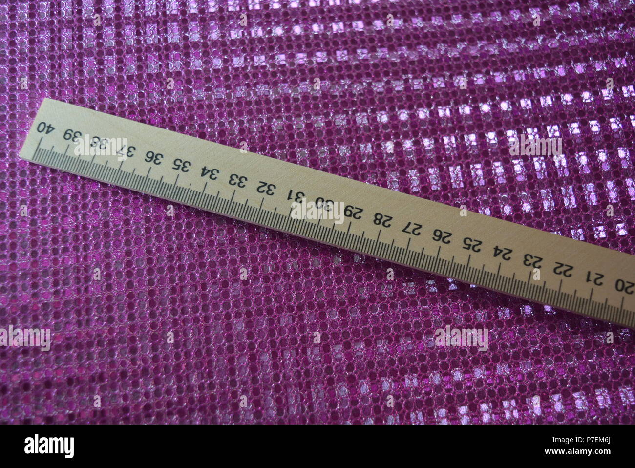 Light wooden mathematical ruler on a pink reflective background Stock ...