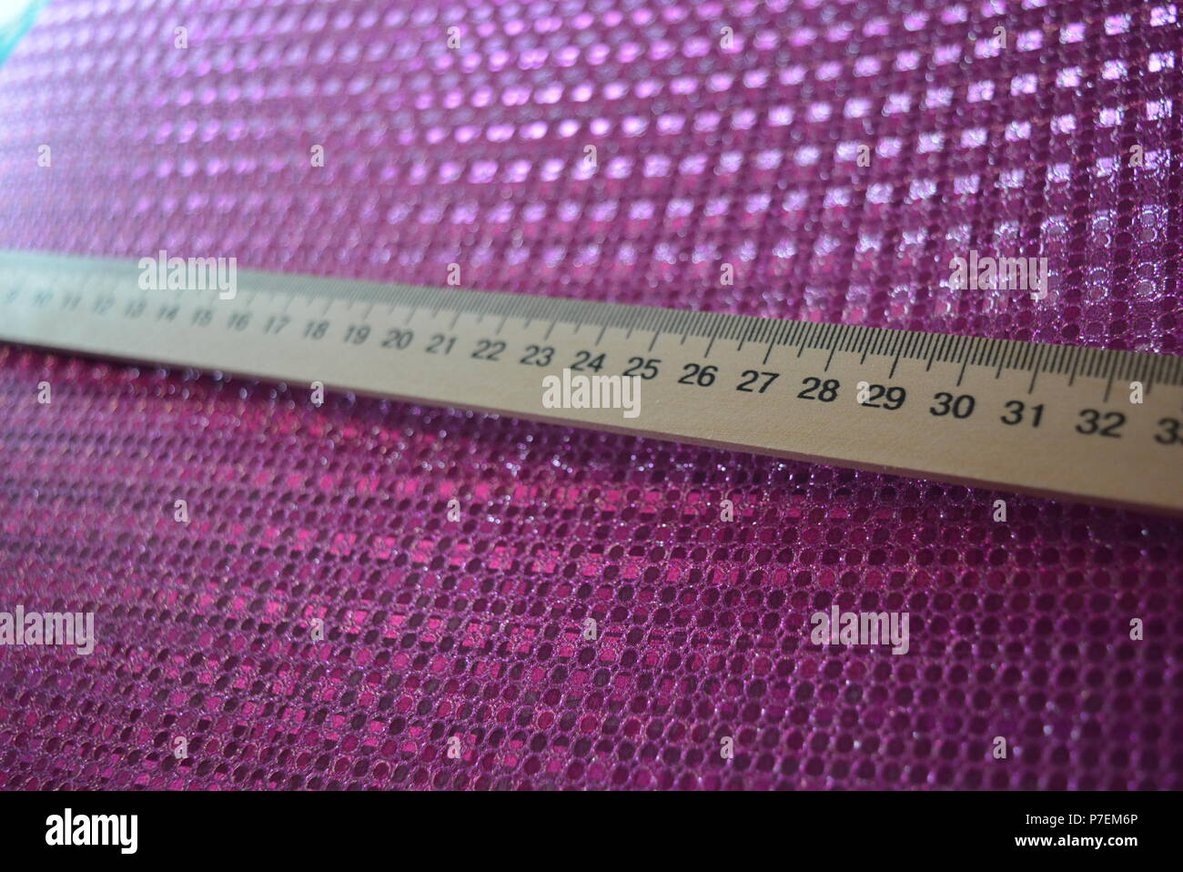 Light wooden mathematical ruler on a pink reflective background Stock ...