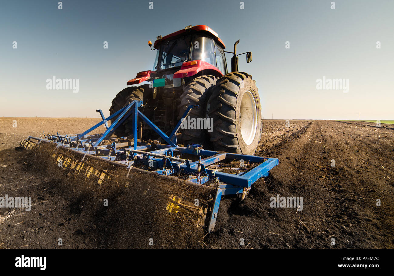 Tractor preparing land for sowing Stock Photo - Alamy