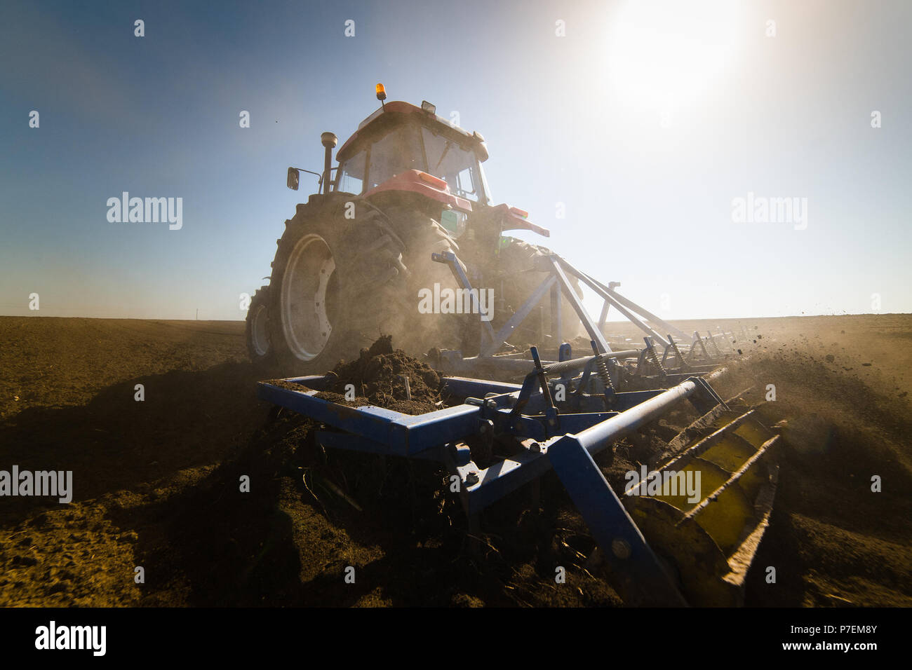 Tractor preparing land for sowing Stock Photo - Alamy